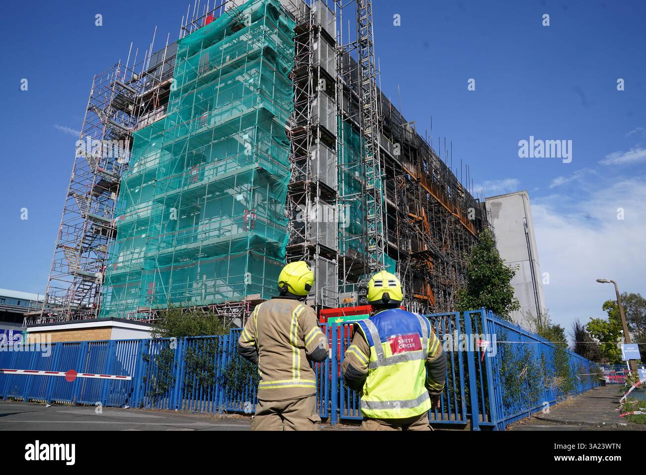 A firefighter and a fire safety officer looking at the scene in ...