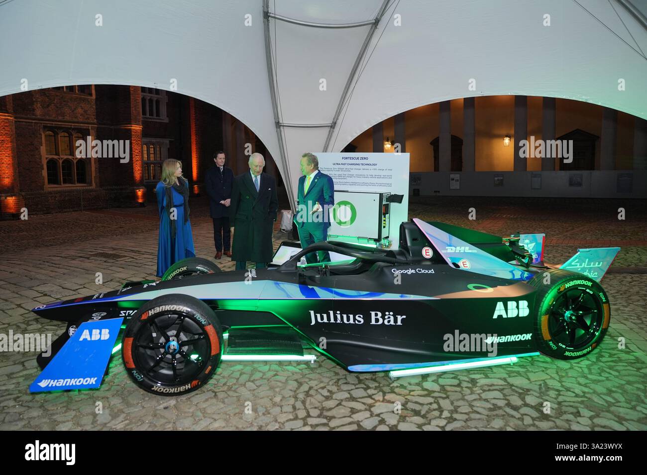 King Charles III looking at a Formula E car with SMI chief executive ...