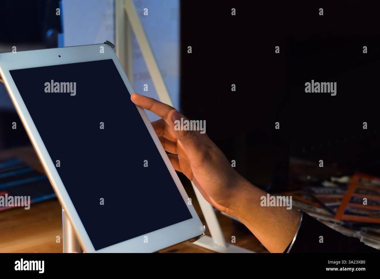 Restaurant employee using POS point of sale system on digital tablet ...