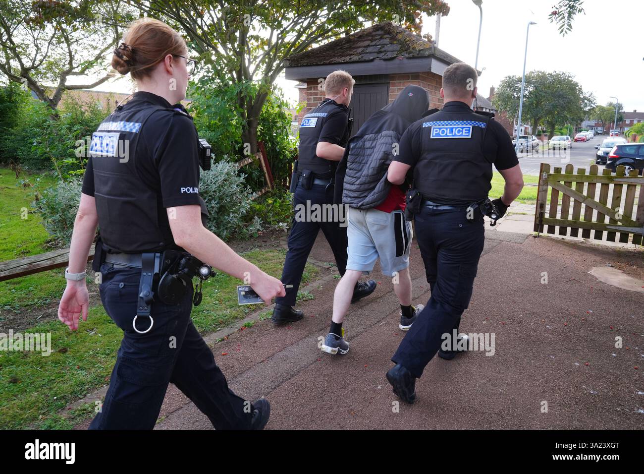 Cleveland Police officers escort a man they've arrested in ...