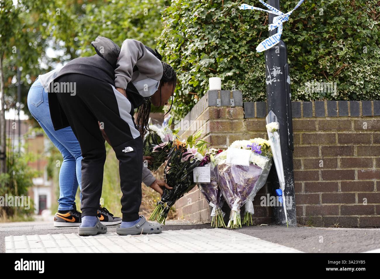 Members of the public lay floral tributes on Overbury Street, near the ...