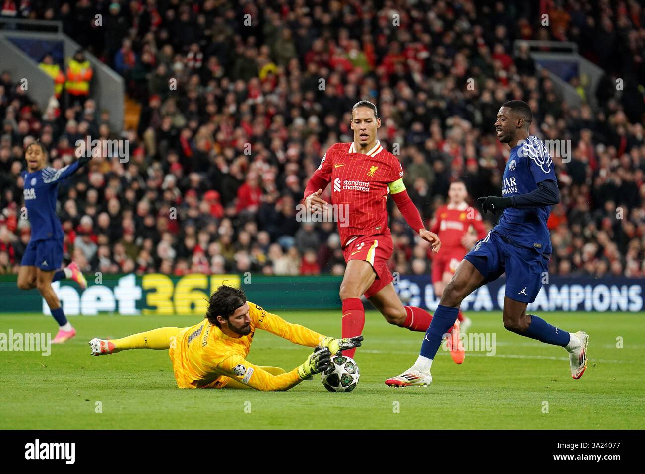 Liverpool goalkeeper Alisson Becker saves at the feet of Paris Saint ...