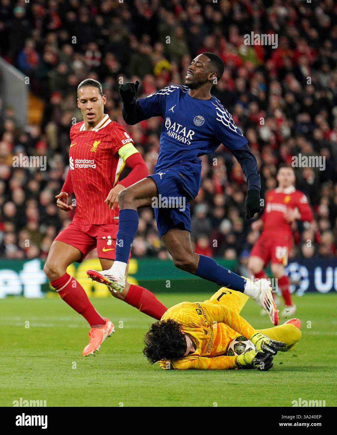 Liverpool goalkeeper Alisson Becker saves at the feet of Paris Saint ...