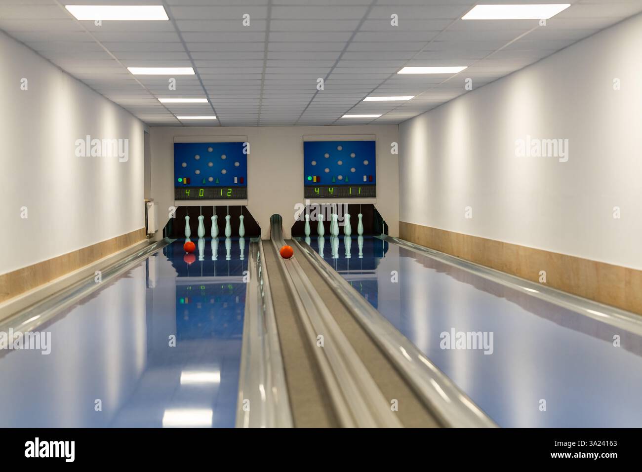 Bowling lanes with neatly arranged pins, ready to play. Surface lanes ...