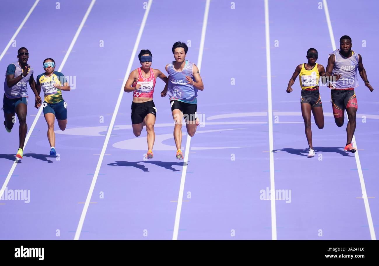 China's Zhou Guohua and guide Gu Dengpu (centre) win the Women's 100m ...