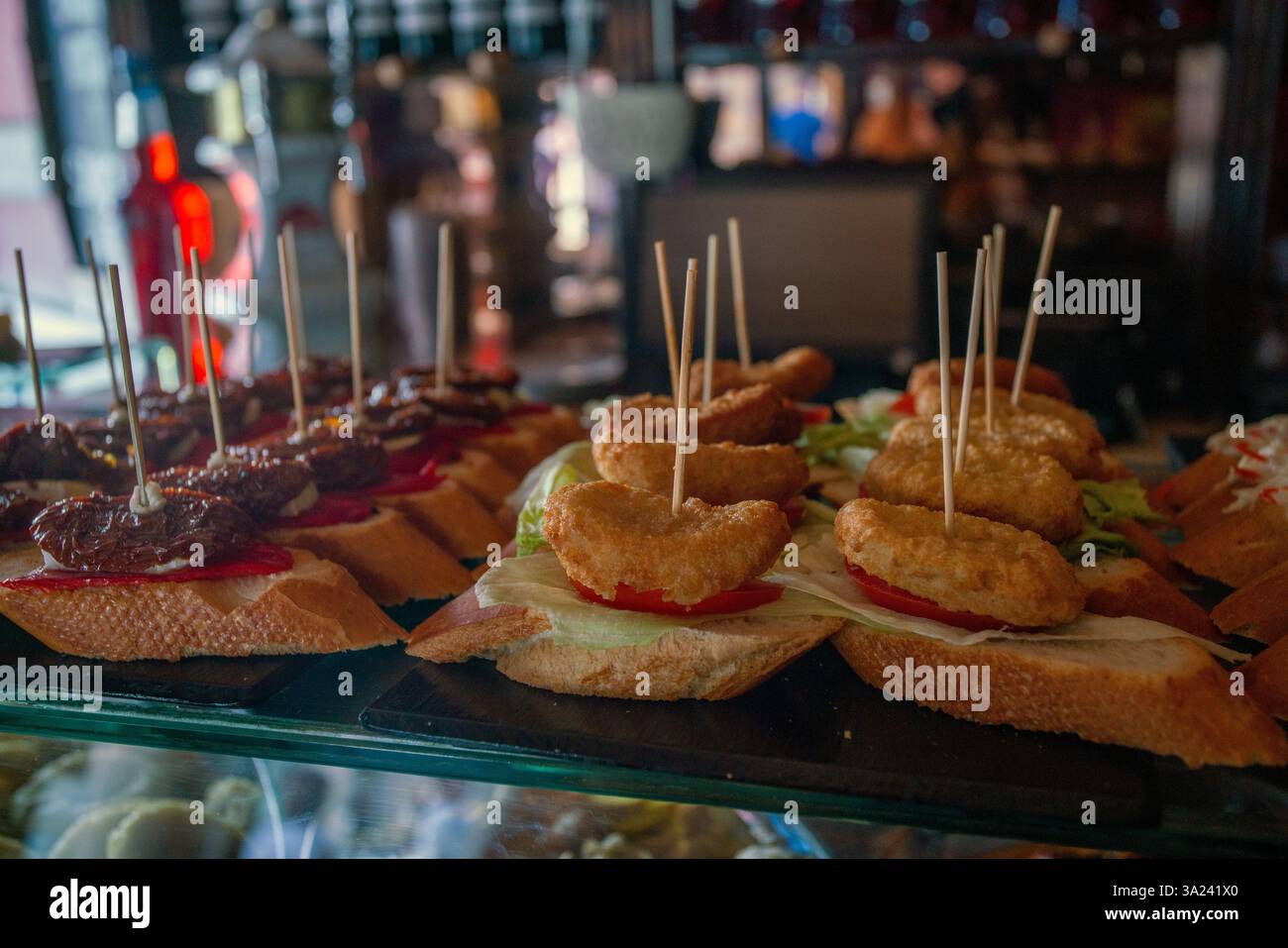 Tapas (pintxos, sandwich) with a small chicken cutlet and a slice of ...