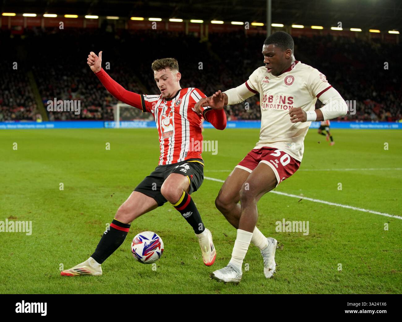 Sheffield United's Harrison Burrows (left) and Bristol City's Sinclair ...