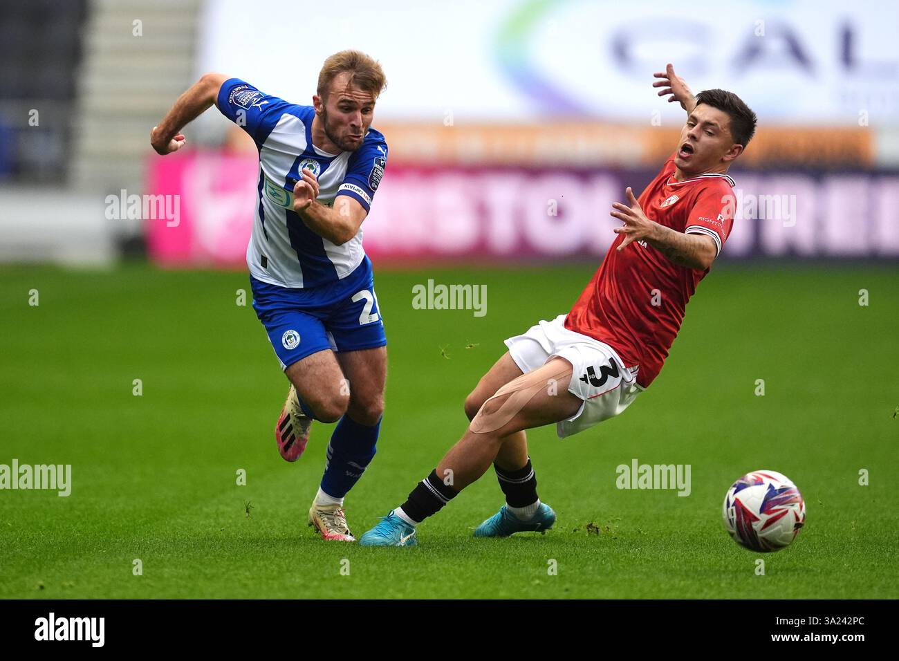Wigan Athletic's Callum McManaman (left) and Morecambe's Adam Lewis ...