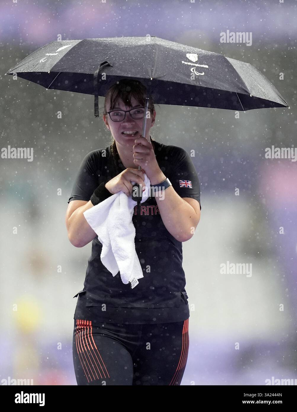 Great Britain's Anna Nicholson stands out in the rain before her event ...
