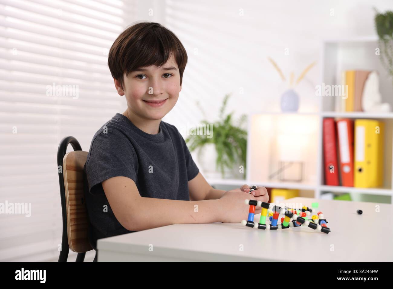 Boy making DNA structure model at desk indoors Stock Photo - Alamy