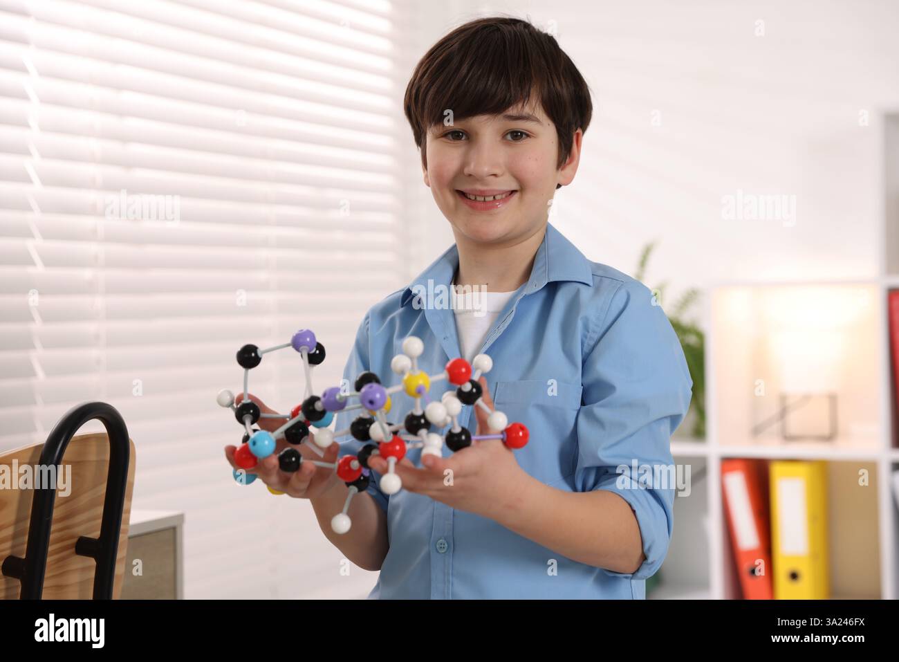 Smiling boy with DNA structure model indoors Stock Photo - Alamy