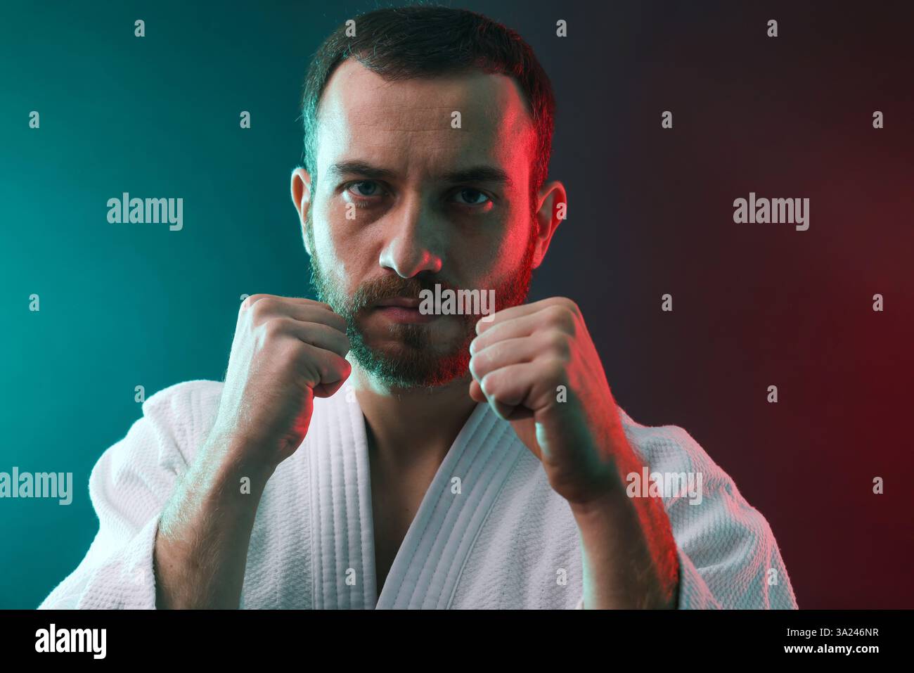 Karate fighter wearing uniform in color lights Stock Photo - Alamy