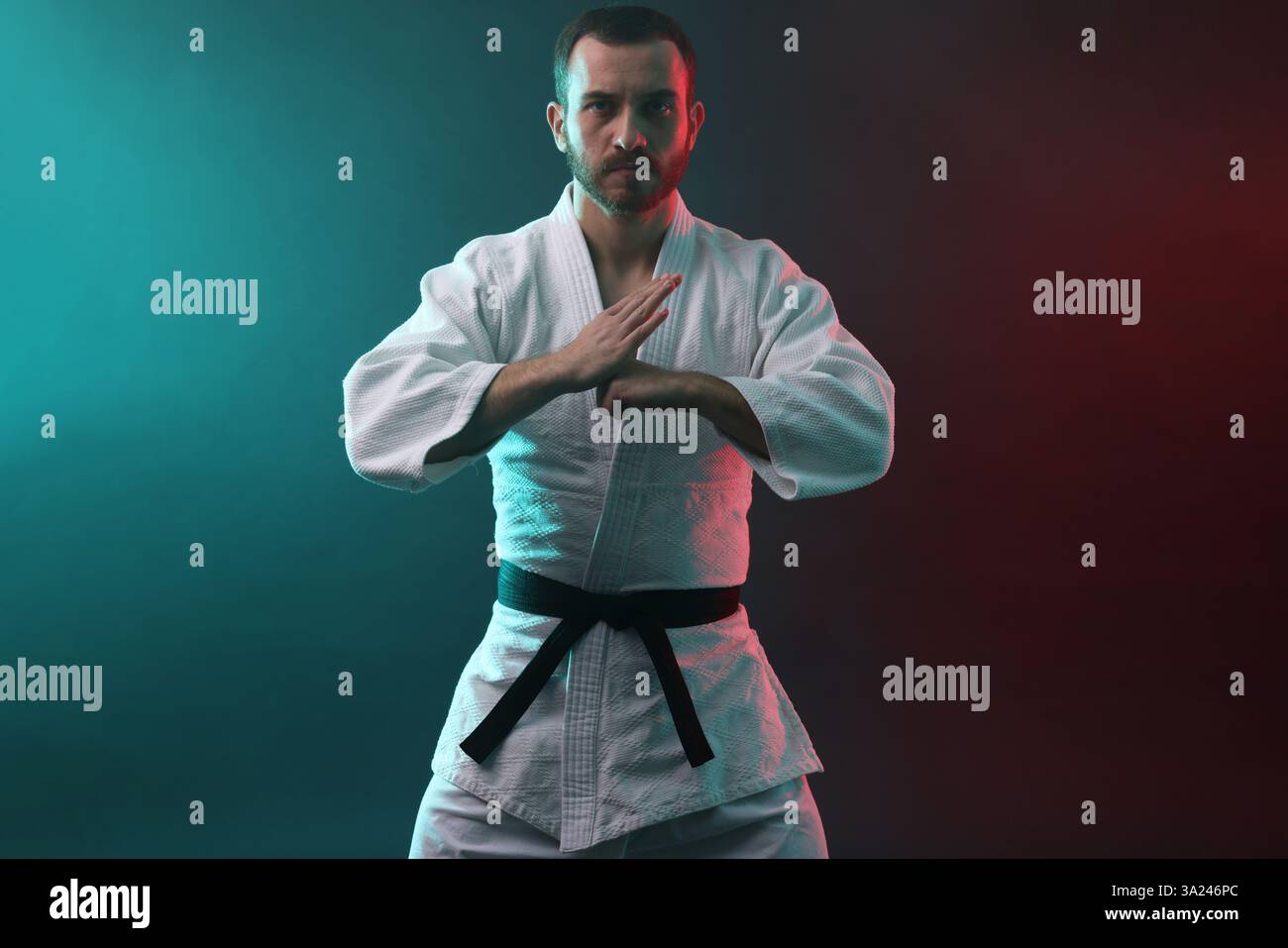 Karate fighter wearing uniform in color lights Stock Photo - Alamy