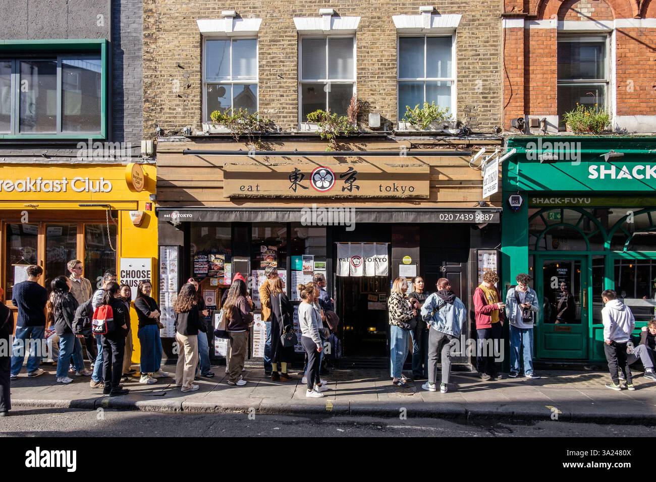 Diners queue outside Japanese restaurant, Old Compton Street, Soho ...