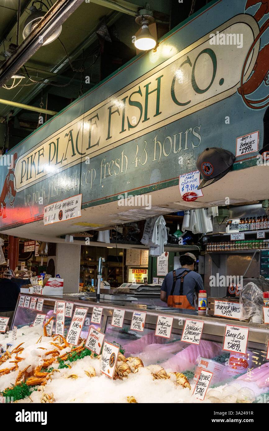 A Pike Place Fish Co. employee stands behind a counter filled with ...