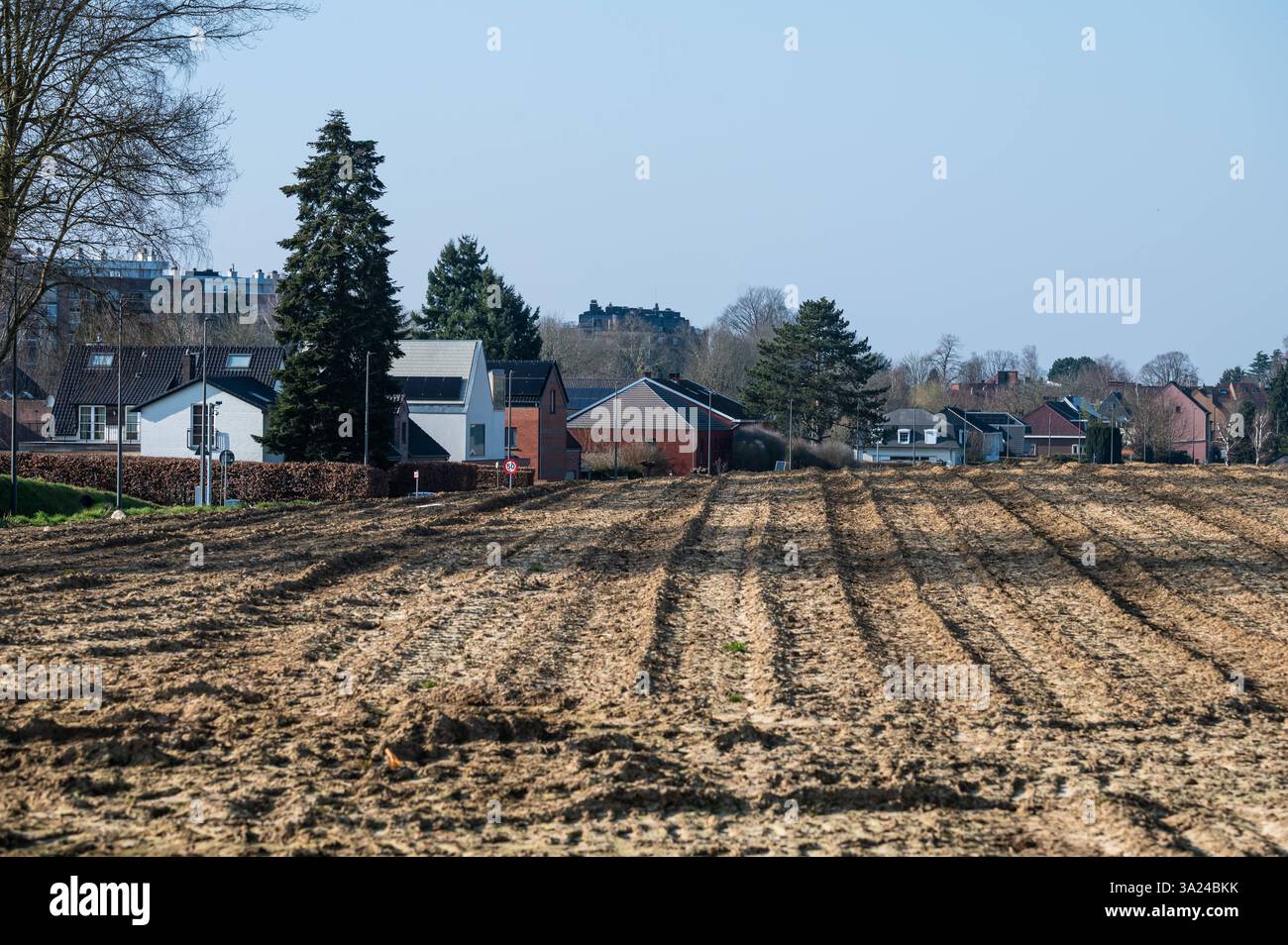 Harvested brown soil and residential houses at the countryside in ...