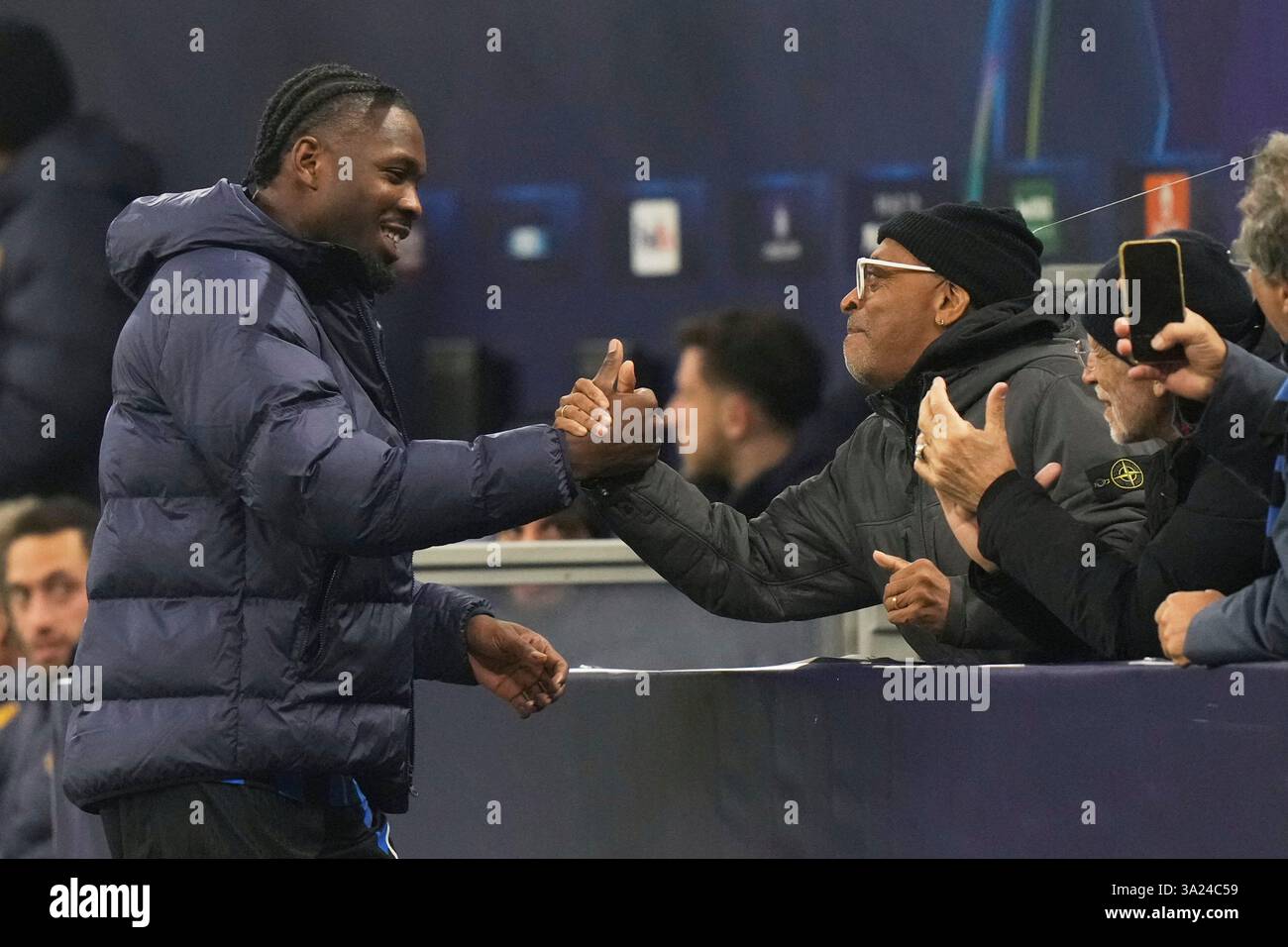 Inter Milan's Marcus Thuram, left, shakes hands with Spike Lee during a Champions League round ...
