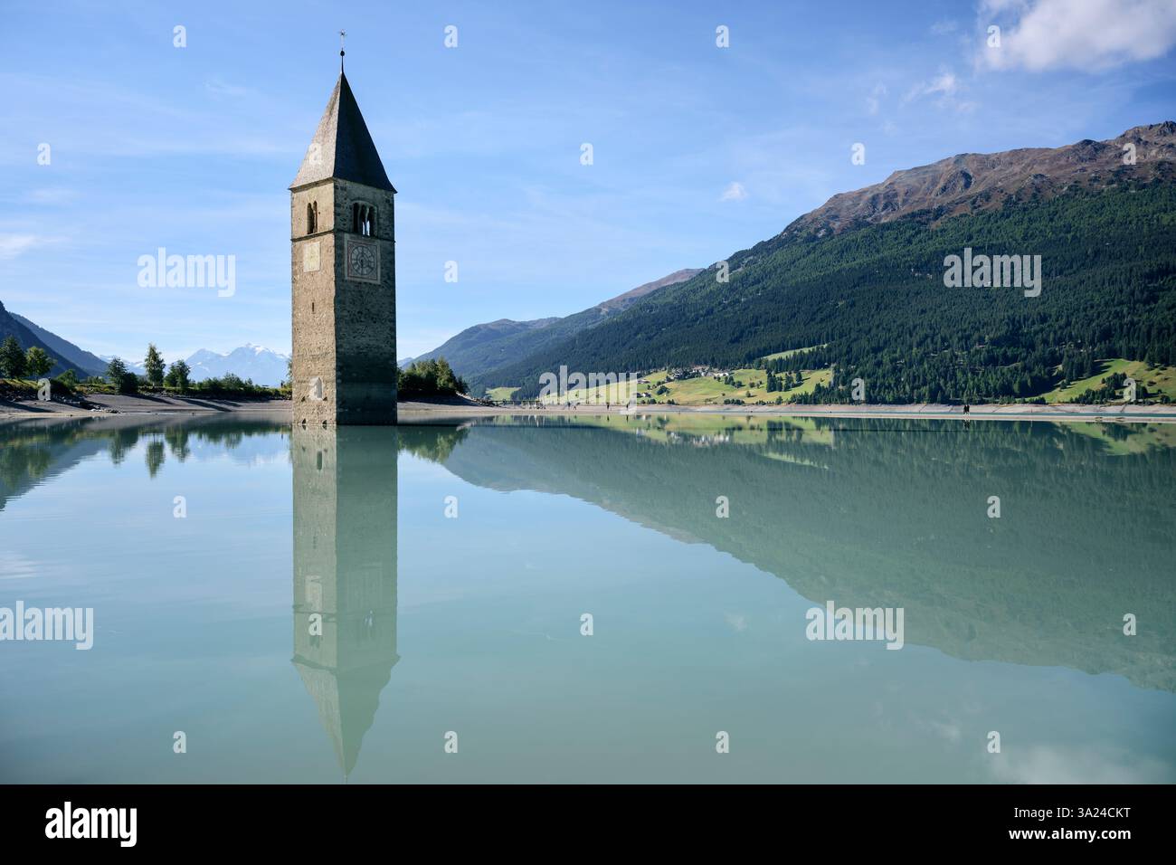 Church tower from the flooded Alt-Graun rises out of the Reschensee ...