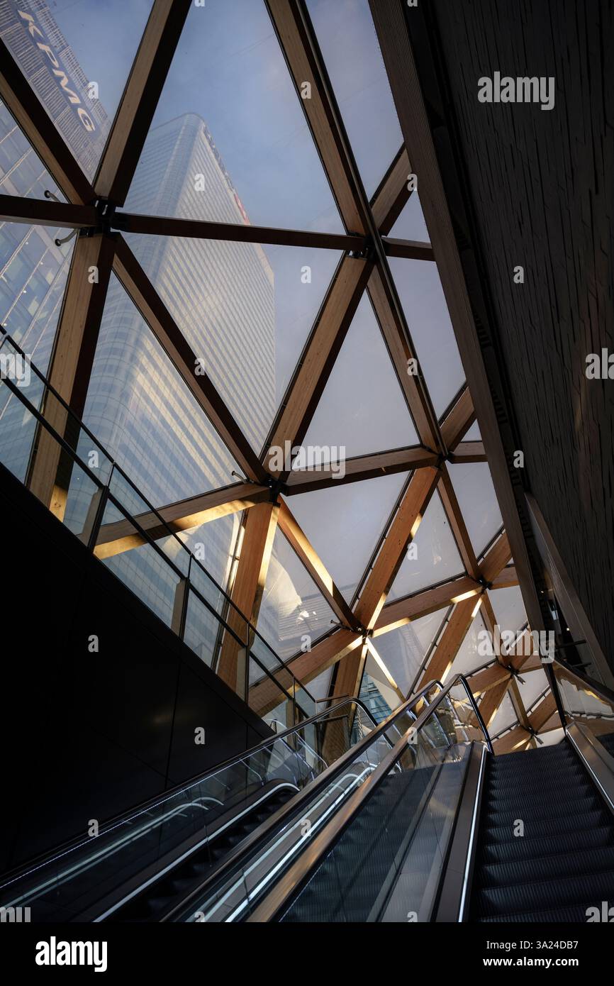 View through the roof structure of Crossrail Place and Garden to the HSBC bank building and the ...