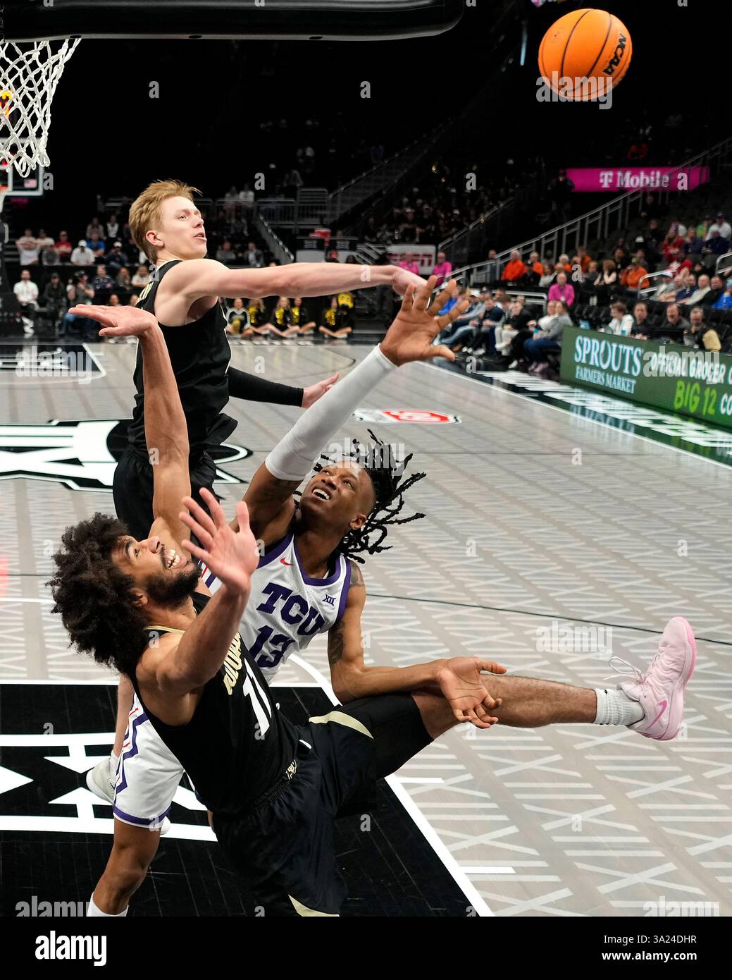 Colorado forward Trevor Baskin, top, and guard Javon Ruffin (11) chase ...