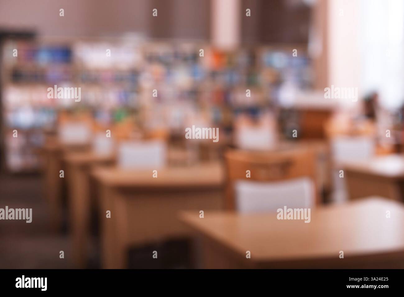 Desks and chairs in public library room, blurred view Stock Photo - Alamy