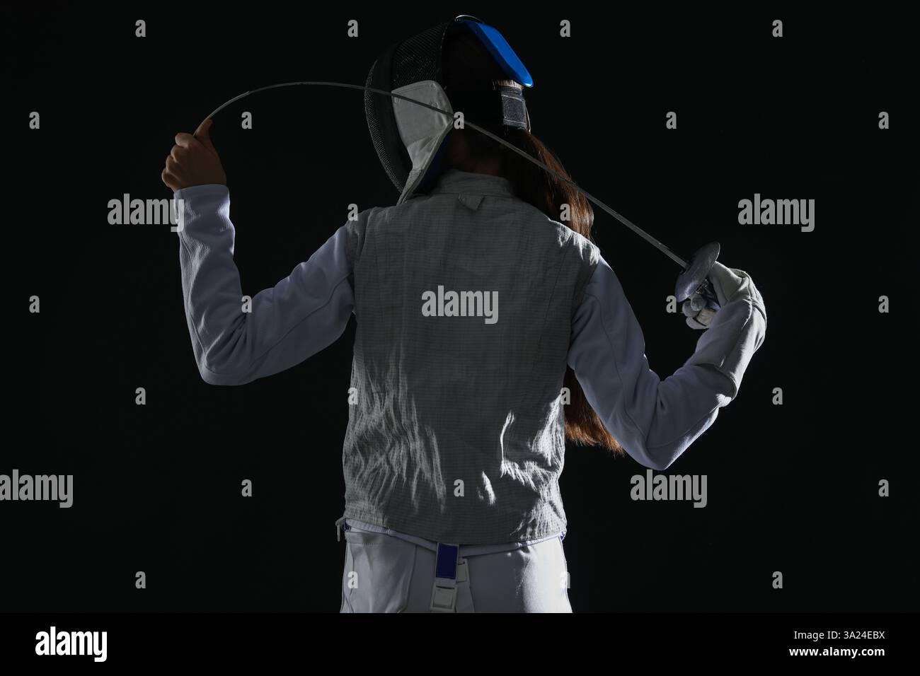 Fencer with epee on black background, back view Stock Photo - Alamy