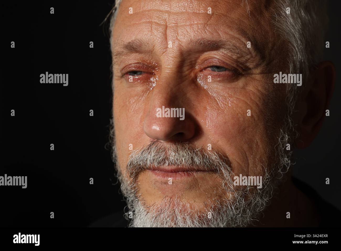 Sad senior man crying on black background, closeup Stock Photo - Alamy