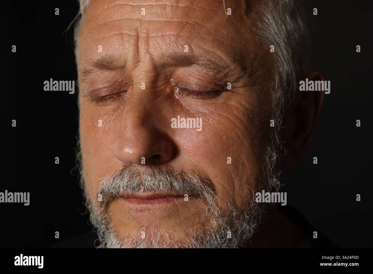 Sad senior man crying on black background, closeup Stock Photo - Alamy