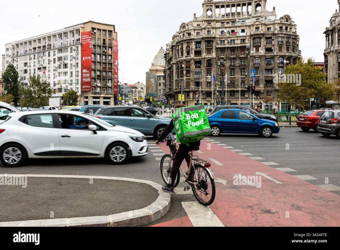 A Bolt food delivery courier on a bike delivers food in Bucharest ...