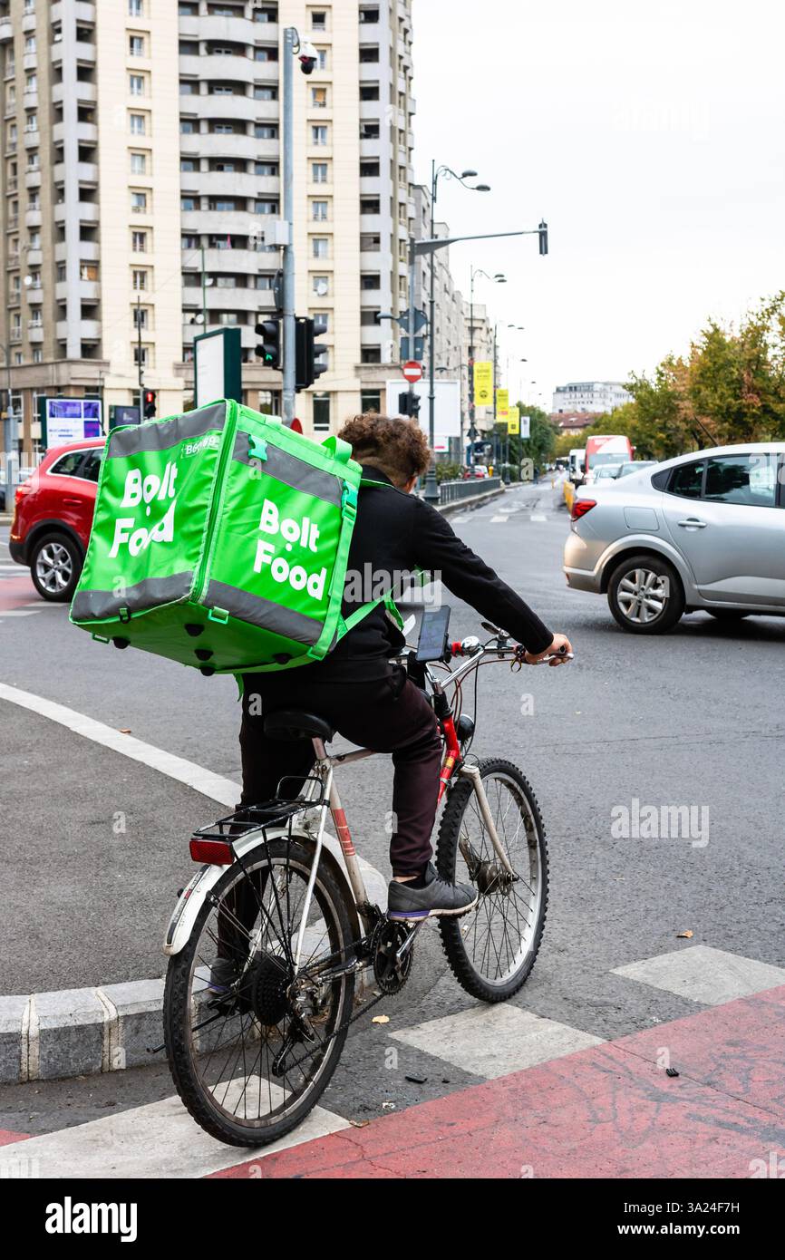 A Bolt food delivery courier on a bike delivers food in Bucharest ...