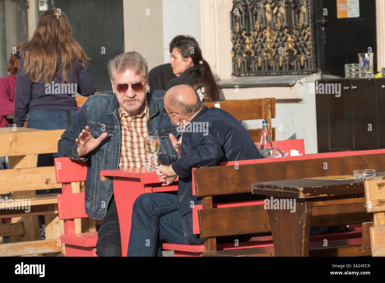 Tourists visiting Bucharest downtown and enjoying local restaurants at ...