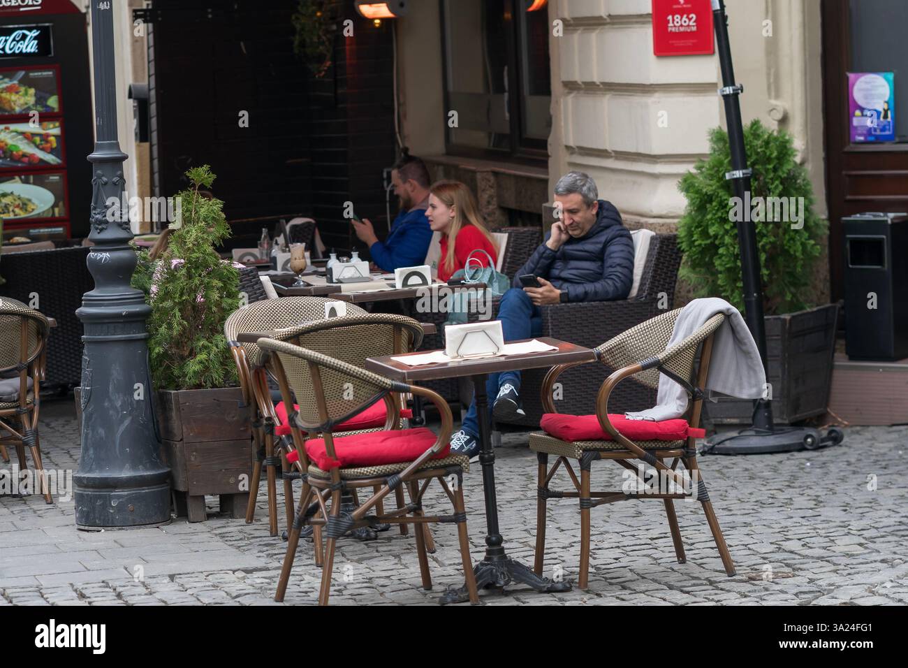 Tourists visiting Bucharest downtown and enjoying local restaurants at ...