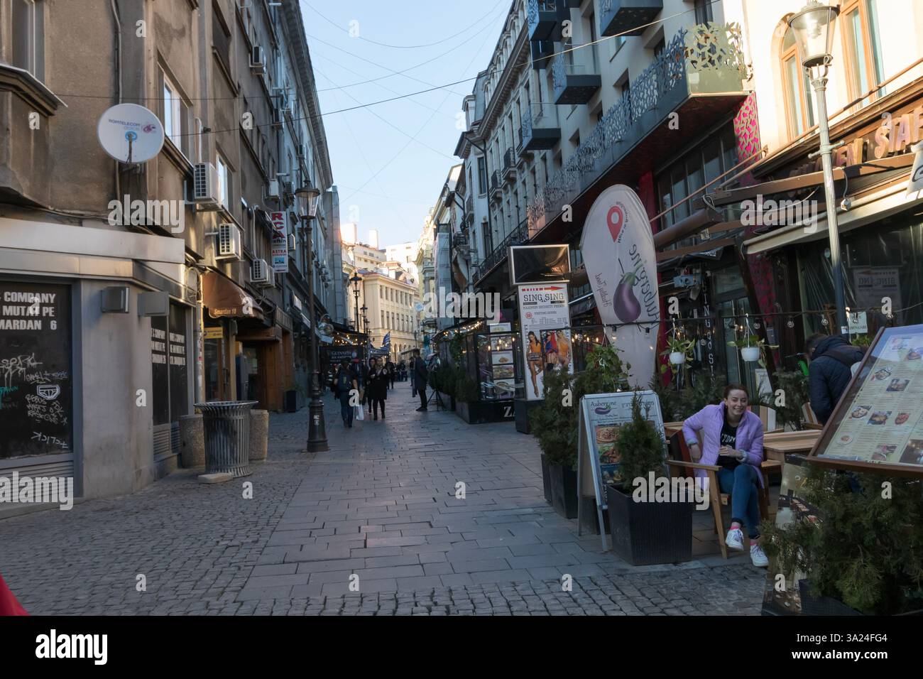 Tourists visiting Bucharest downtown and enjoying local restaurants at ...