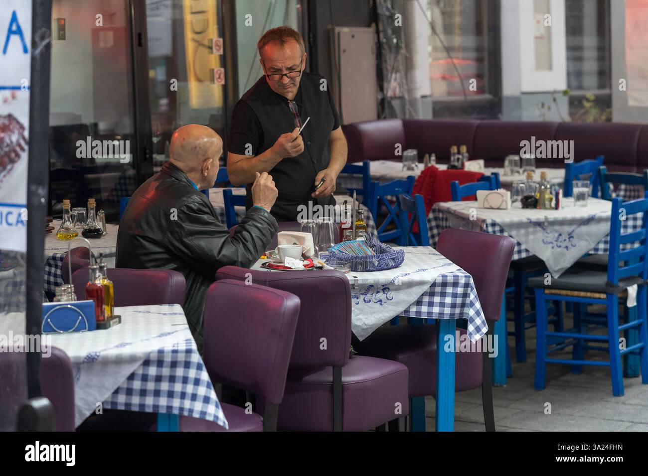 Tourists visiting Bucharest downtown and enjoying local restaurants at ...