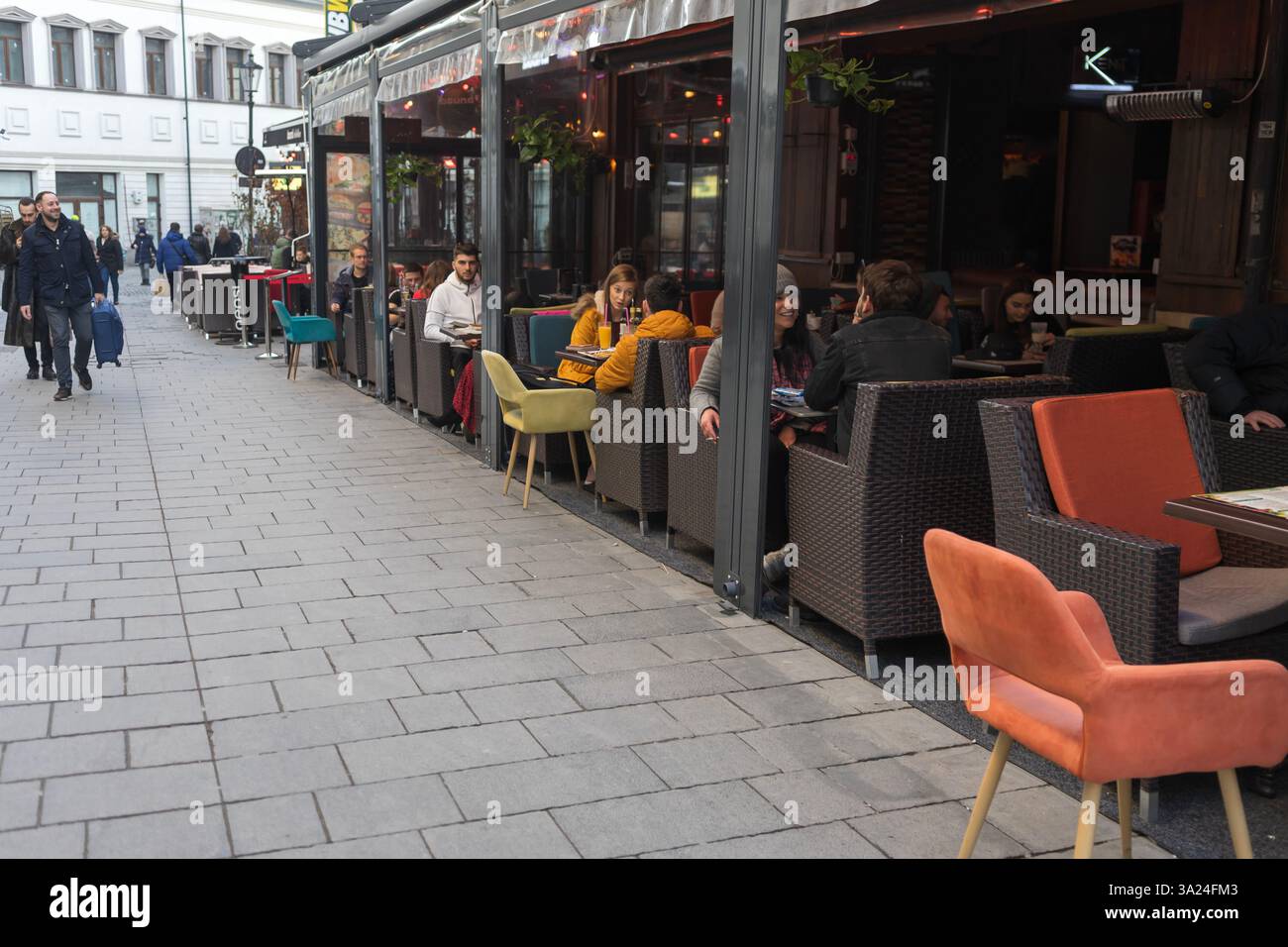 Tourists visiting Bucharest downtown and enjoying local restaurants at ...