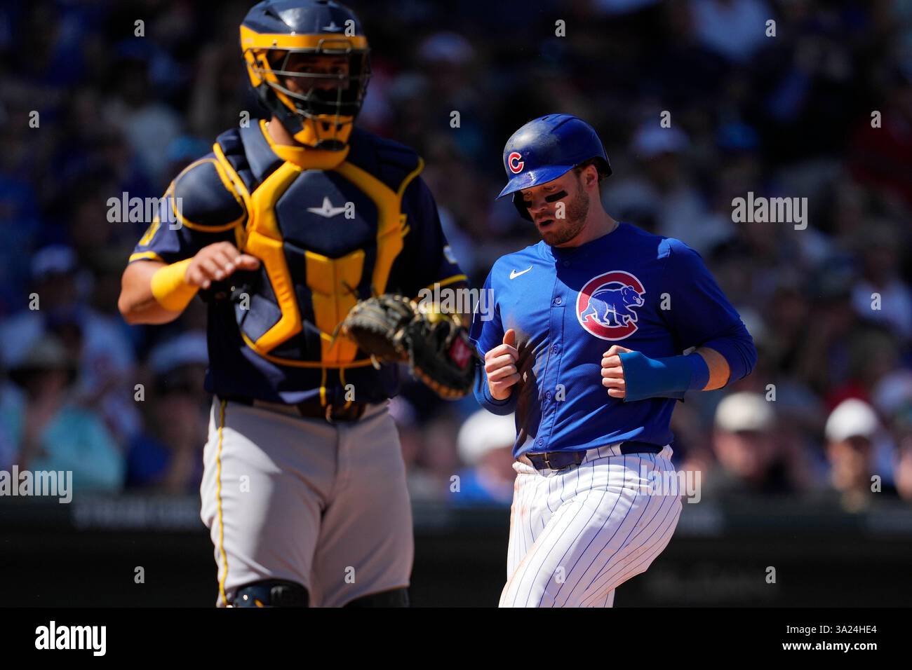 Chicago Cubs' Ian Happ scores on a wild pitch as Milwaukee Brewers ...