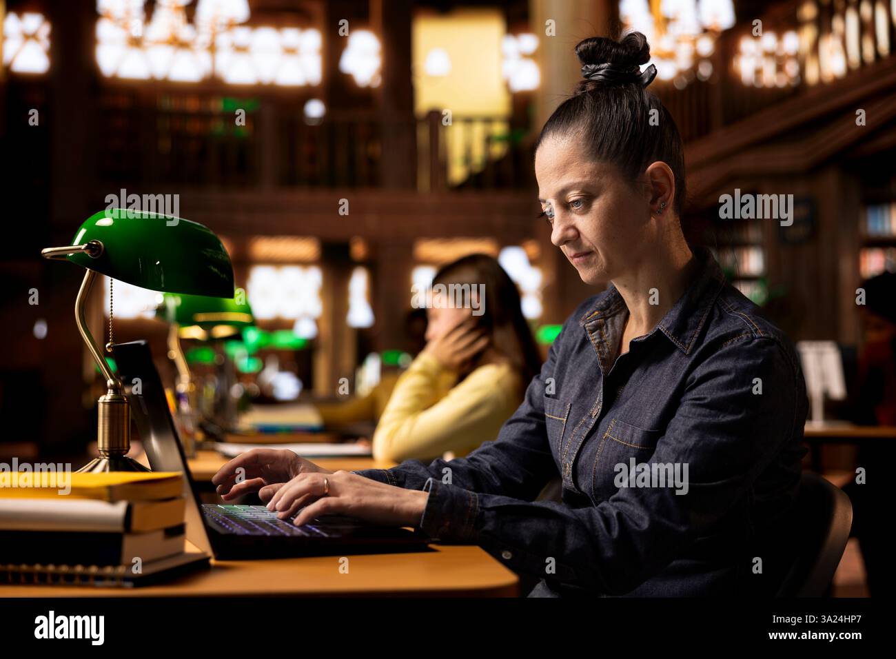 Librarian completing notes on learning materials to help students with ...