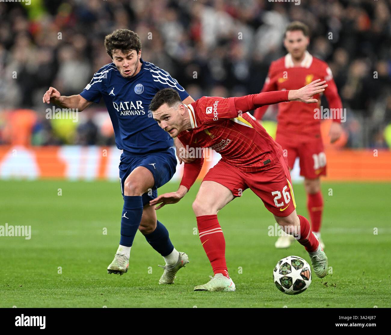 Liverpool, UK. 11th Mar, 2025. Andrew Robertson of Liverpool with Joao Neves of Paris St Germain ...