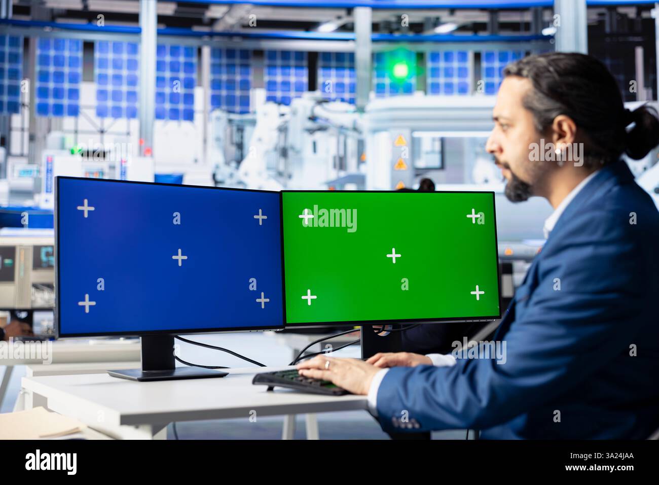 Engineer in photovoltaics factory reviewing system logs on isolated ...