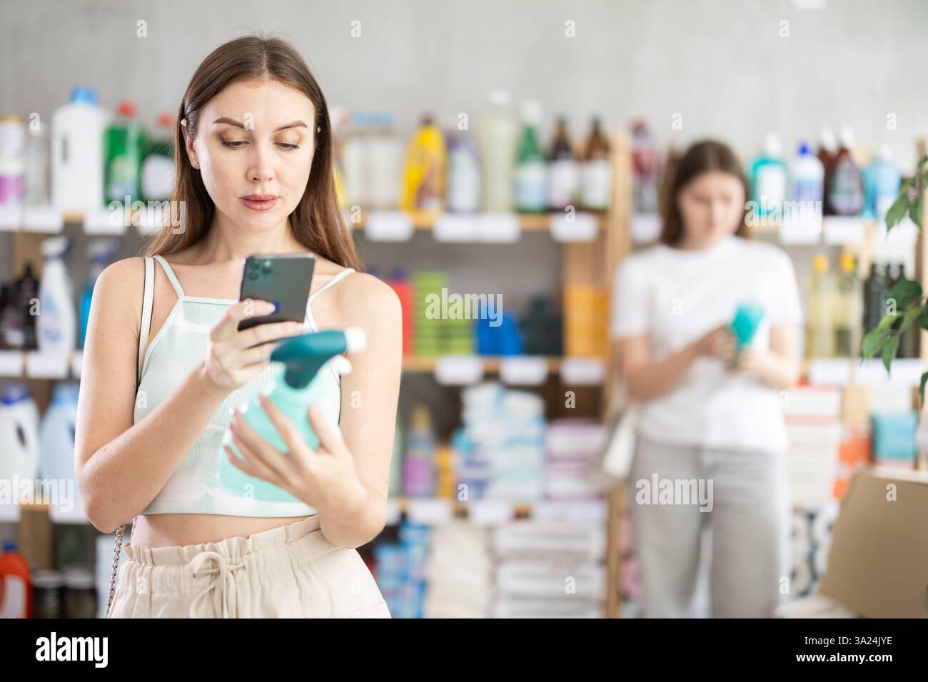 woman scanning spray barcode on her phone Stock Photo - Alamy