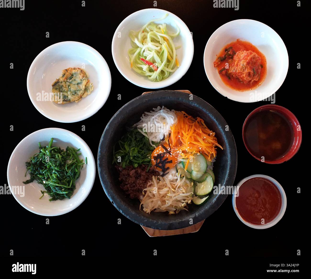 Bibimbap or Bi Bim Bap, traditional Korean Food with small bowls of ...