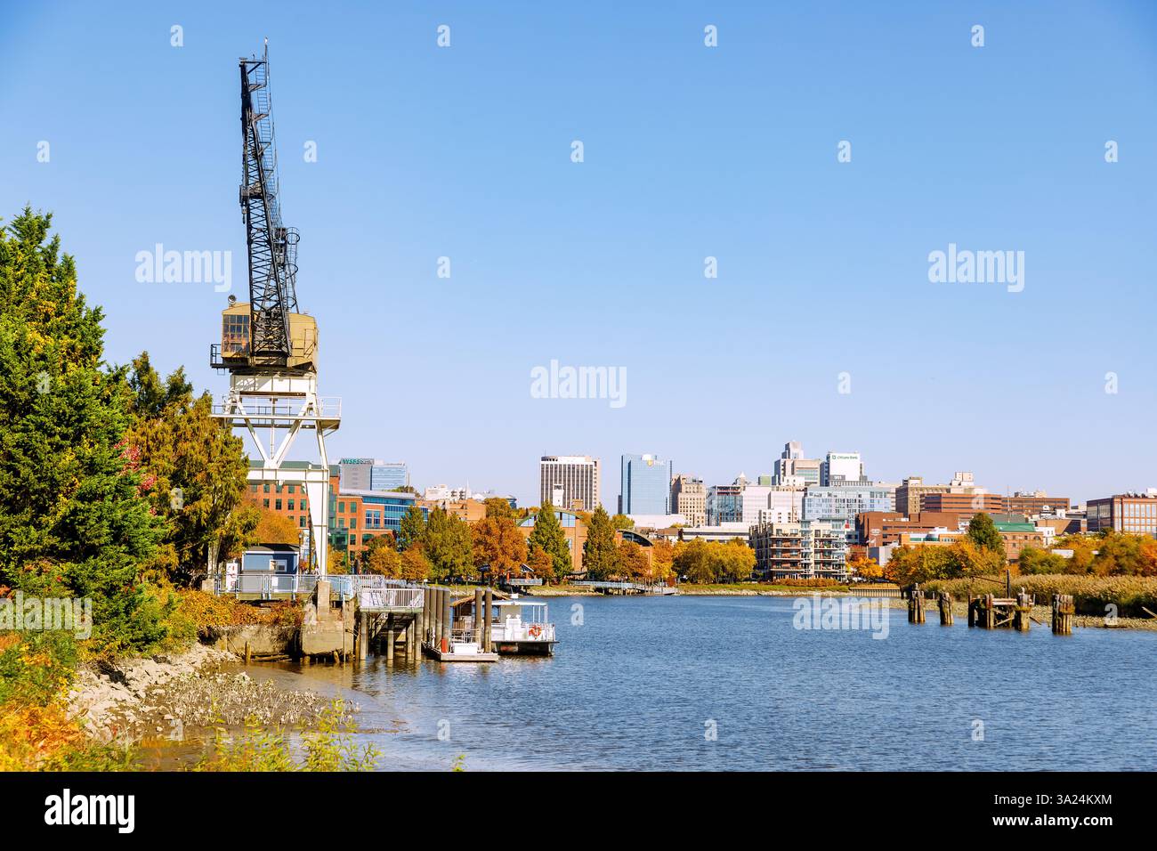 River Walk with historic harbor crane on the Christina River and view ...