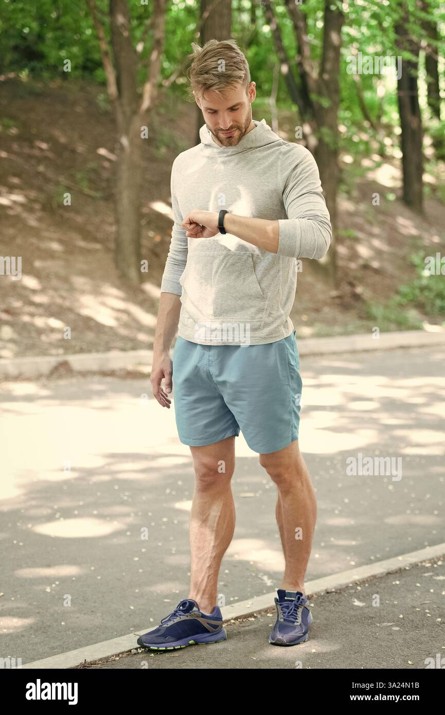 Man runner with fitness gadget. Smartwatch for fitness. Sporty fit man with sport equipment ...