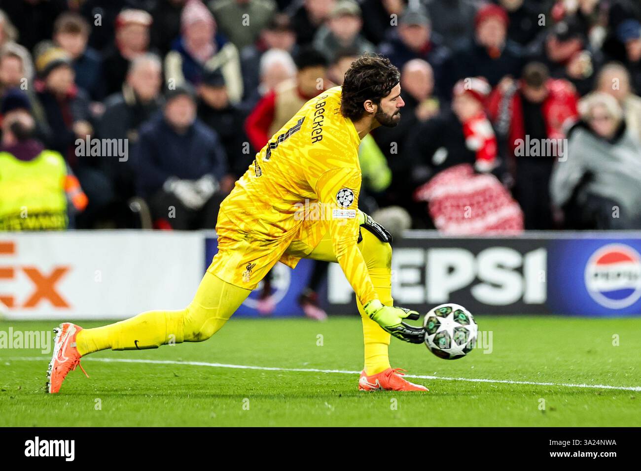 Alisson Becker of Liverpool passes the ball during the UEFA Champions ...