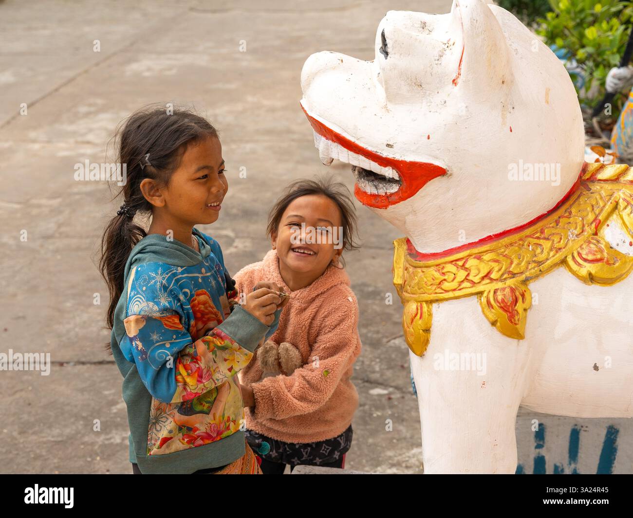 children playing at a sculpture of dogs guarding the main staircase of ...