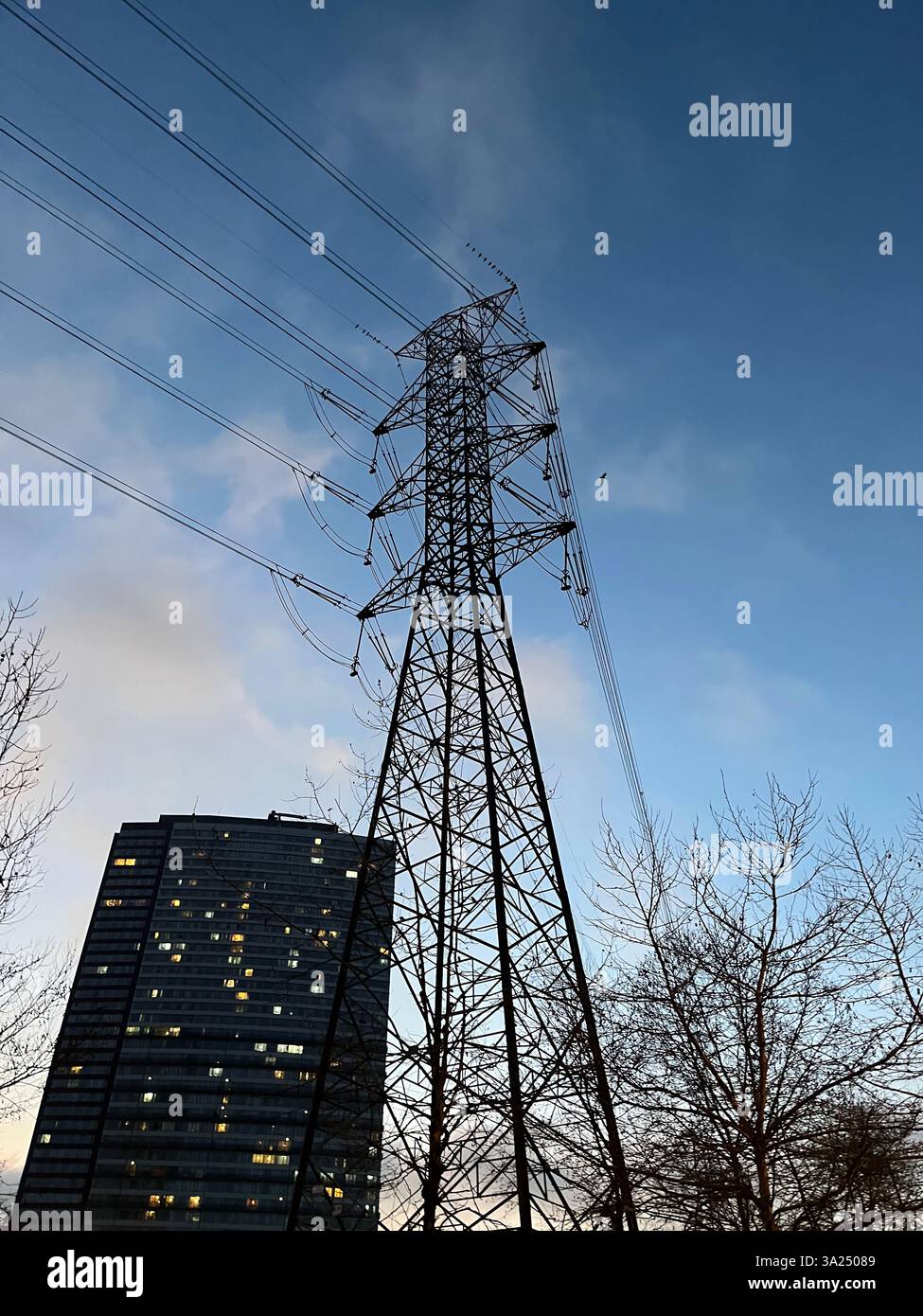 Electric transmission tower with buildings silhouette in Istanbul ...