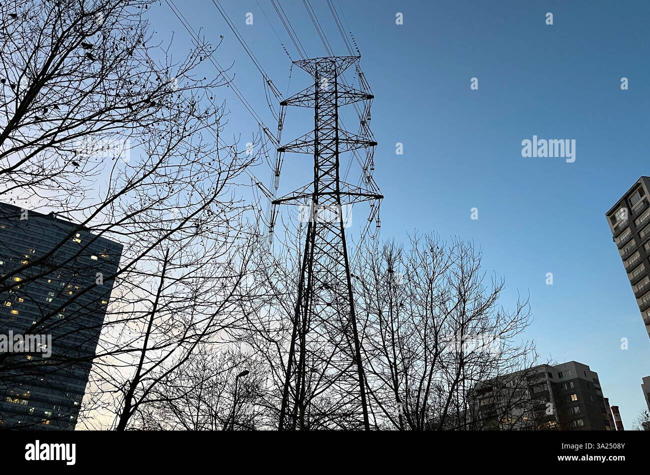 Electric transmission tower with buildings silhouette in Istanbul ...