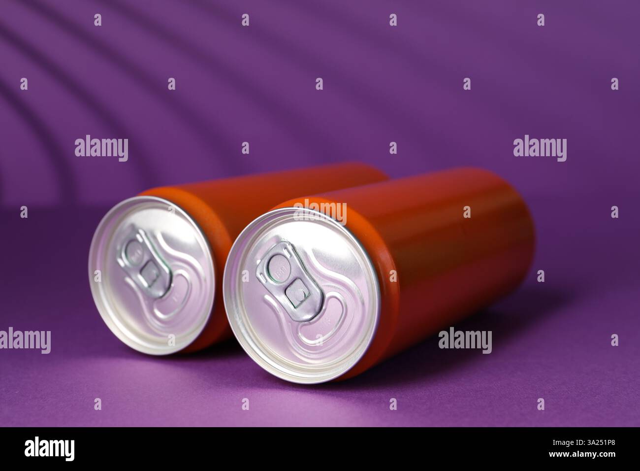 Two tin cans on purple background with shadow, closeup Stock Photo - Alamy