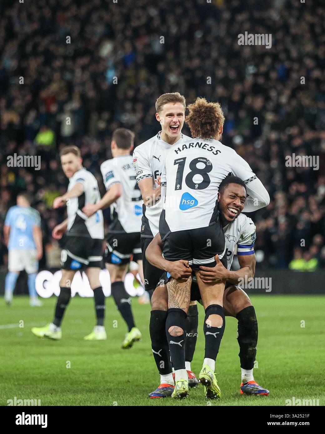 Goalscorer #18, Marcus Harness is lifted off his feet by #32, Ebou ...