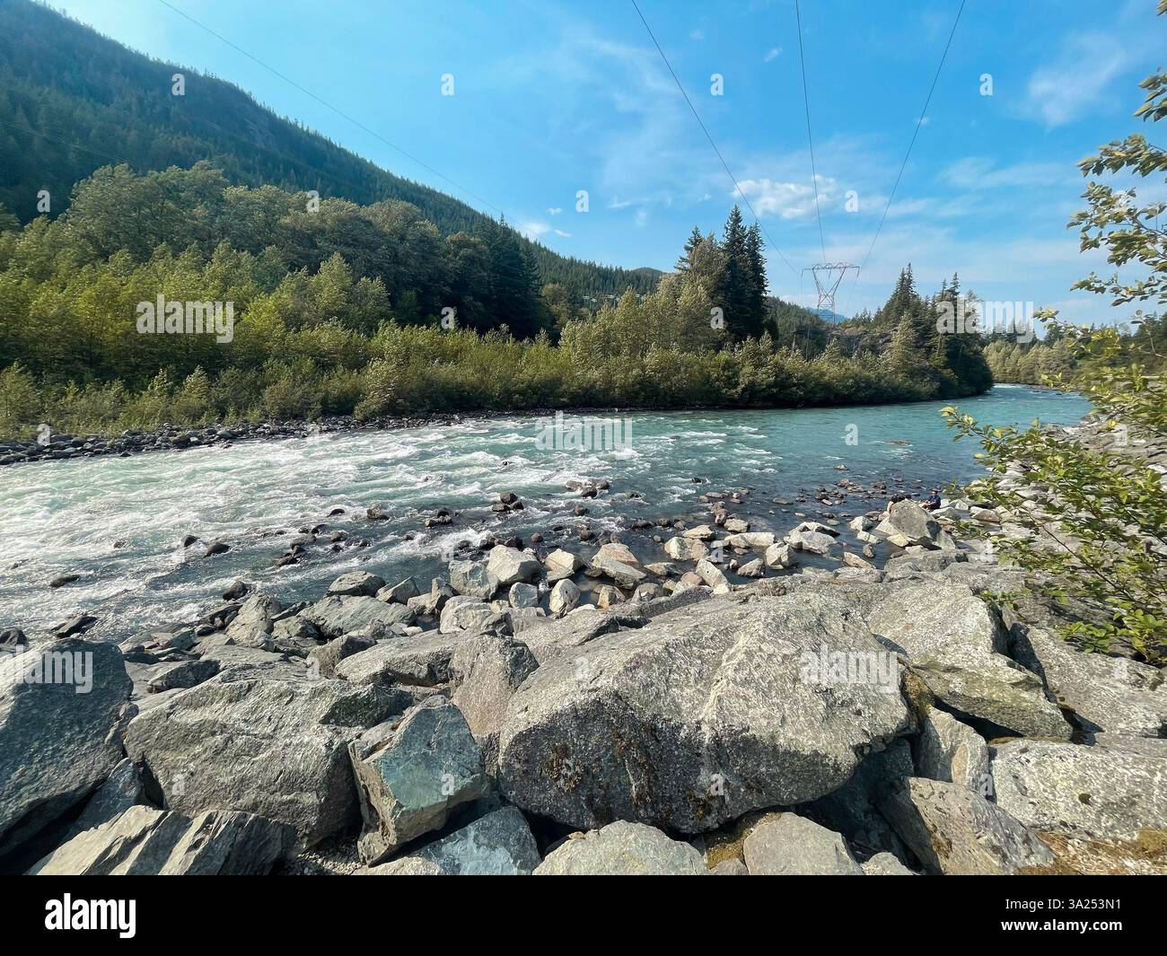 A pristine river flowing through the Canadian wilderness, surrounded by ...